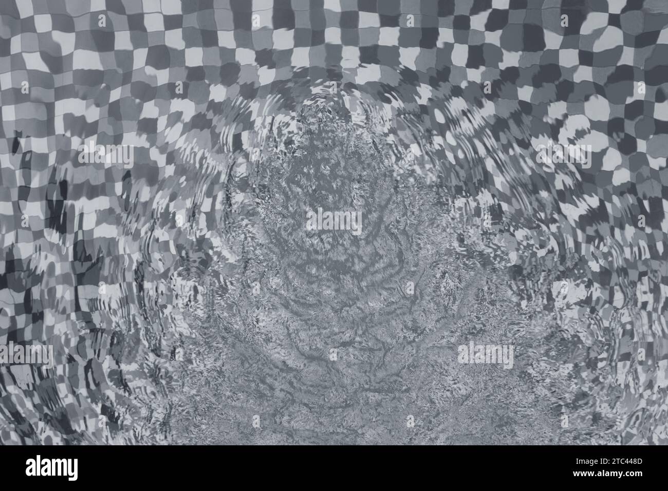 Rippled water and swimming pool mosaic tiles viewed from above ...