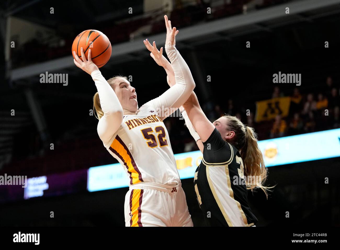 Minnesota center Sophie Hart (52) goes up for a shot as Purdue forward ...