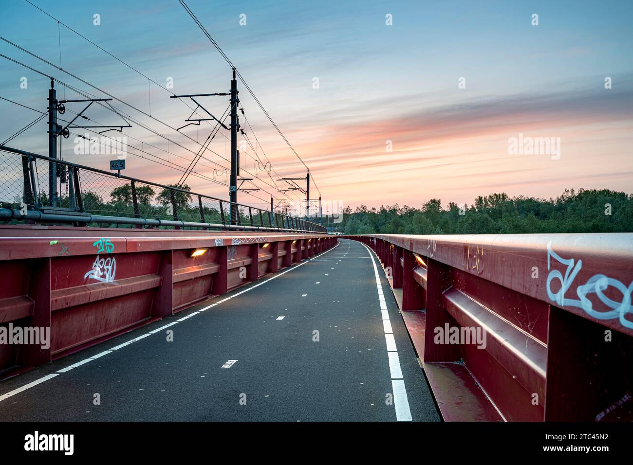 Red railroad bridge named 'Hanzeboog' over the IJssel river in the ...