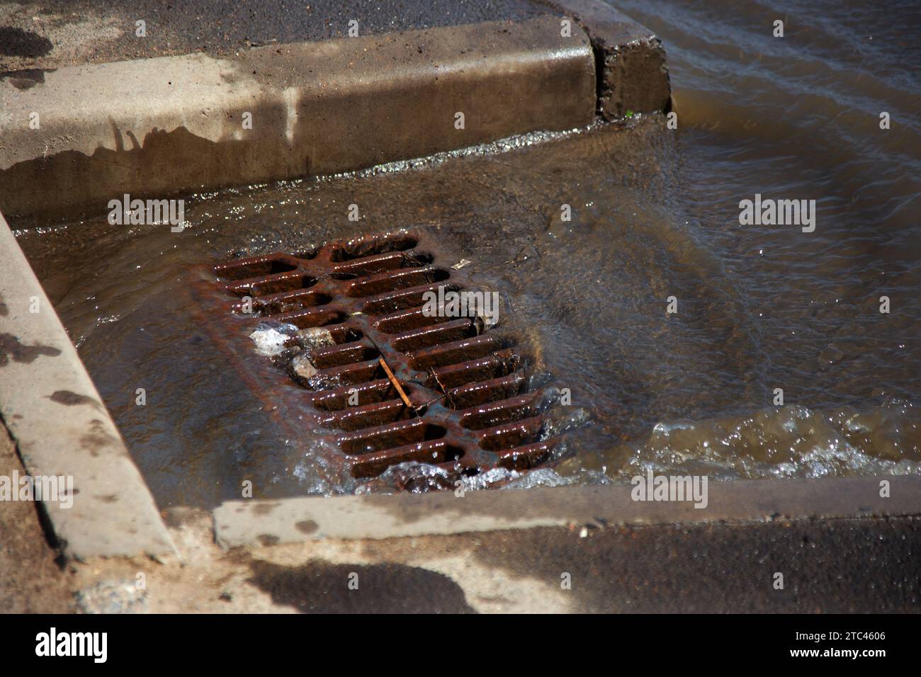 Flow of water during heavy rain and clogging of street sewage. The flow ...