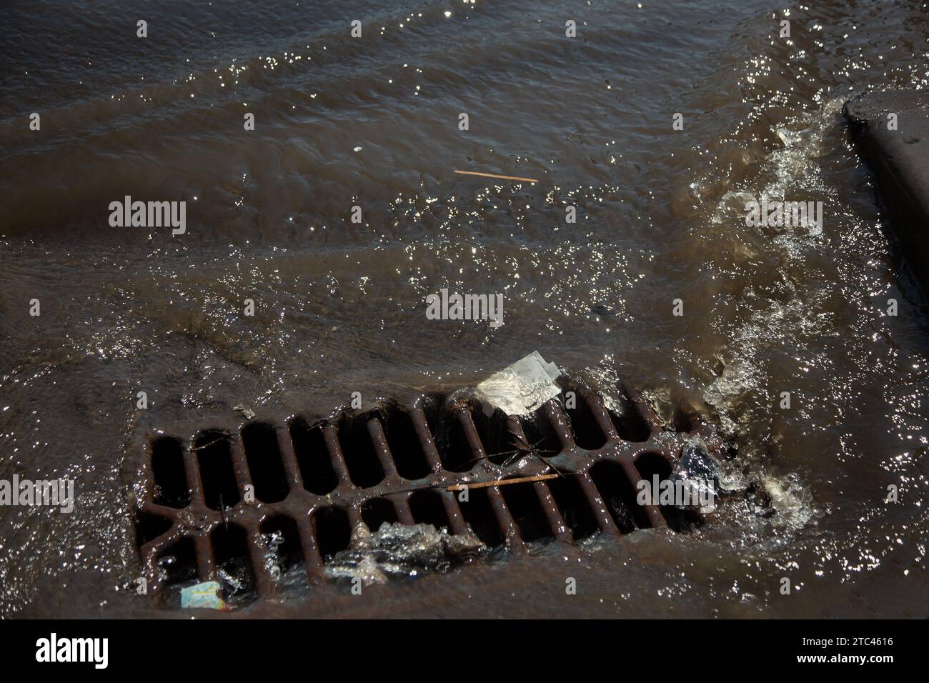 Flow of water during heavy rain and clogging of street sewage. The flow ...