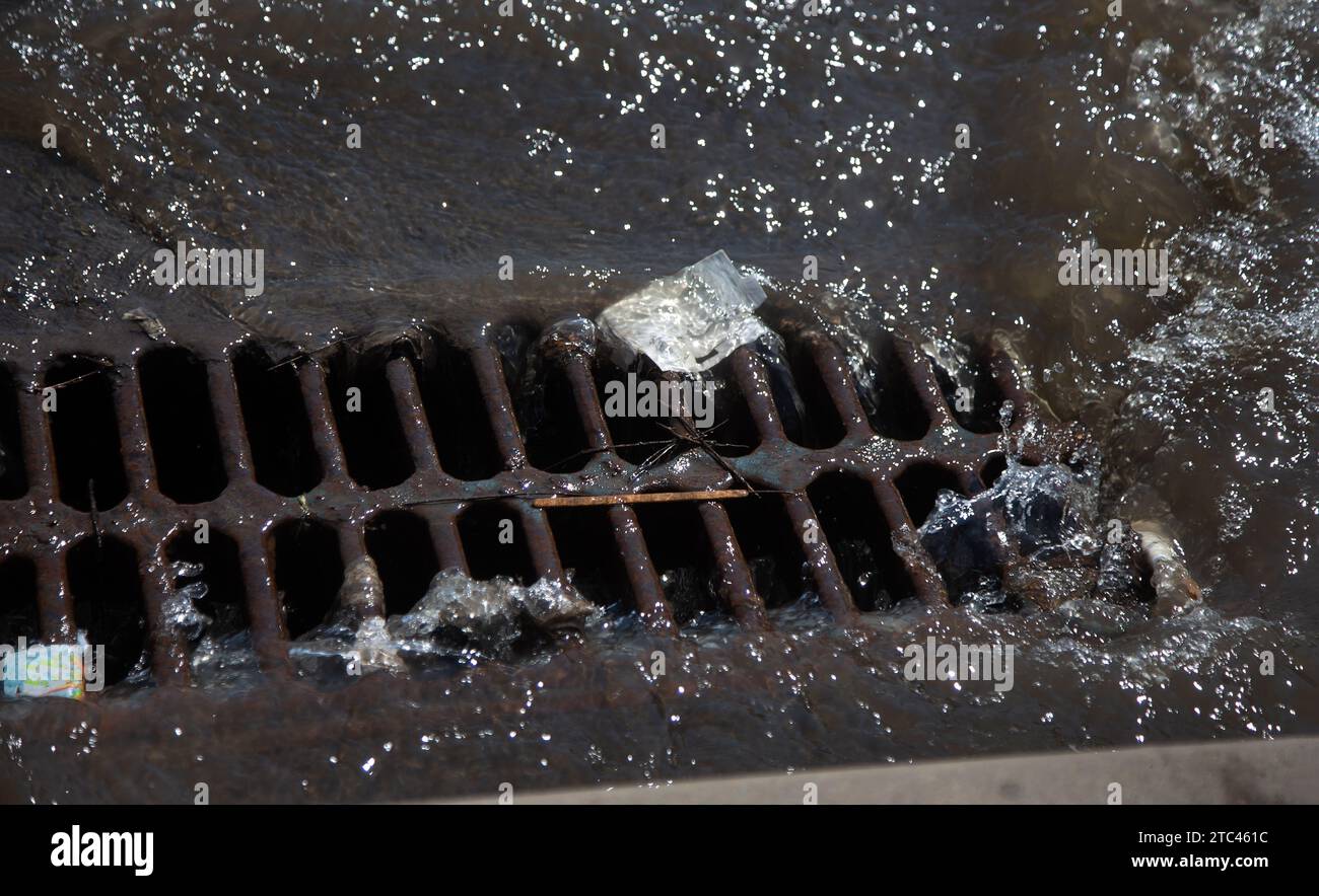 Flow of water during heavy rain and clogging of street sewage. The flow ...