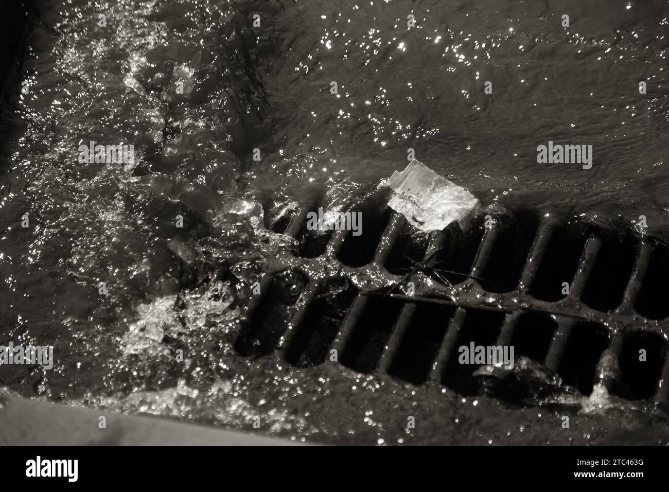 Flow of water during heavy rain and clogging of street sewage. The flow ...
