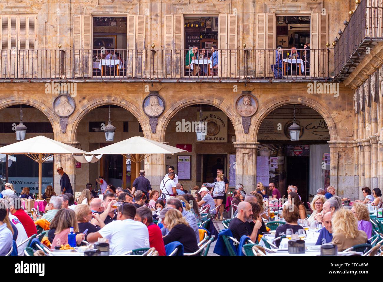 People sitting outside in the sunshine eating and drinking in the Plaza ...