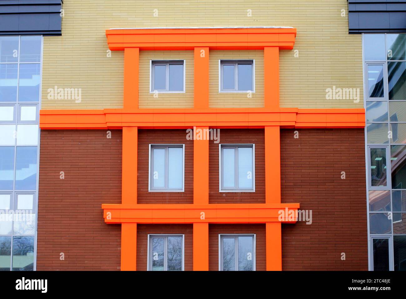 Facade of modern building, house with large windows, orange brown walls ...