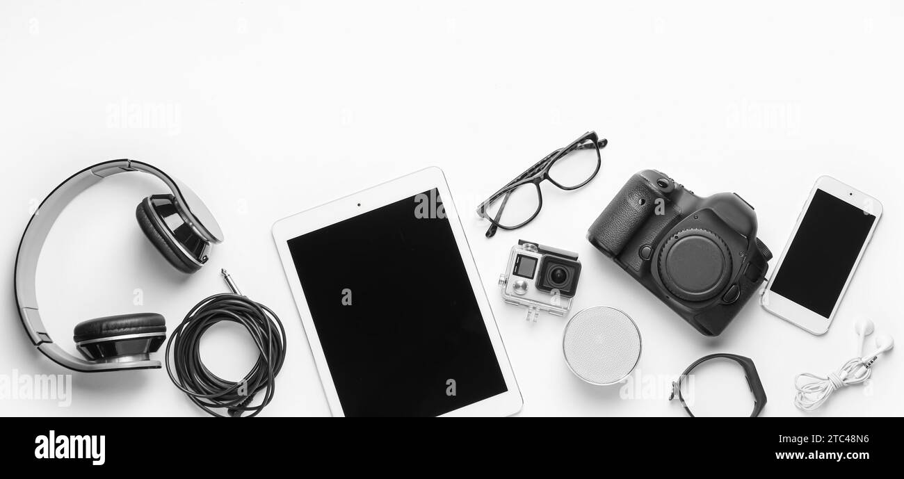 Different modern devices, gadgets and eyeglasses on white background ...