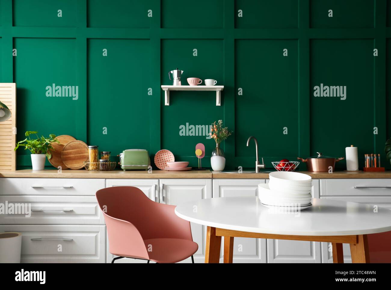 Interior of modern kitchen with white counters and dining table Stock ...