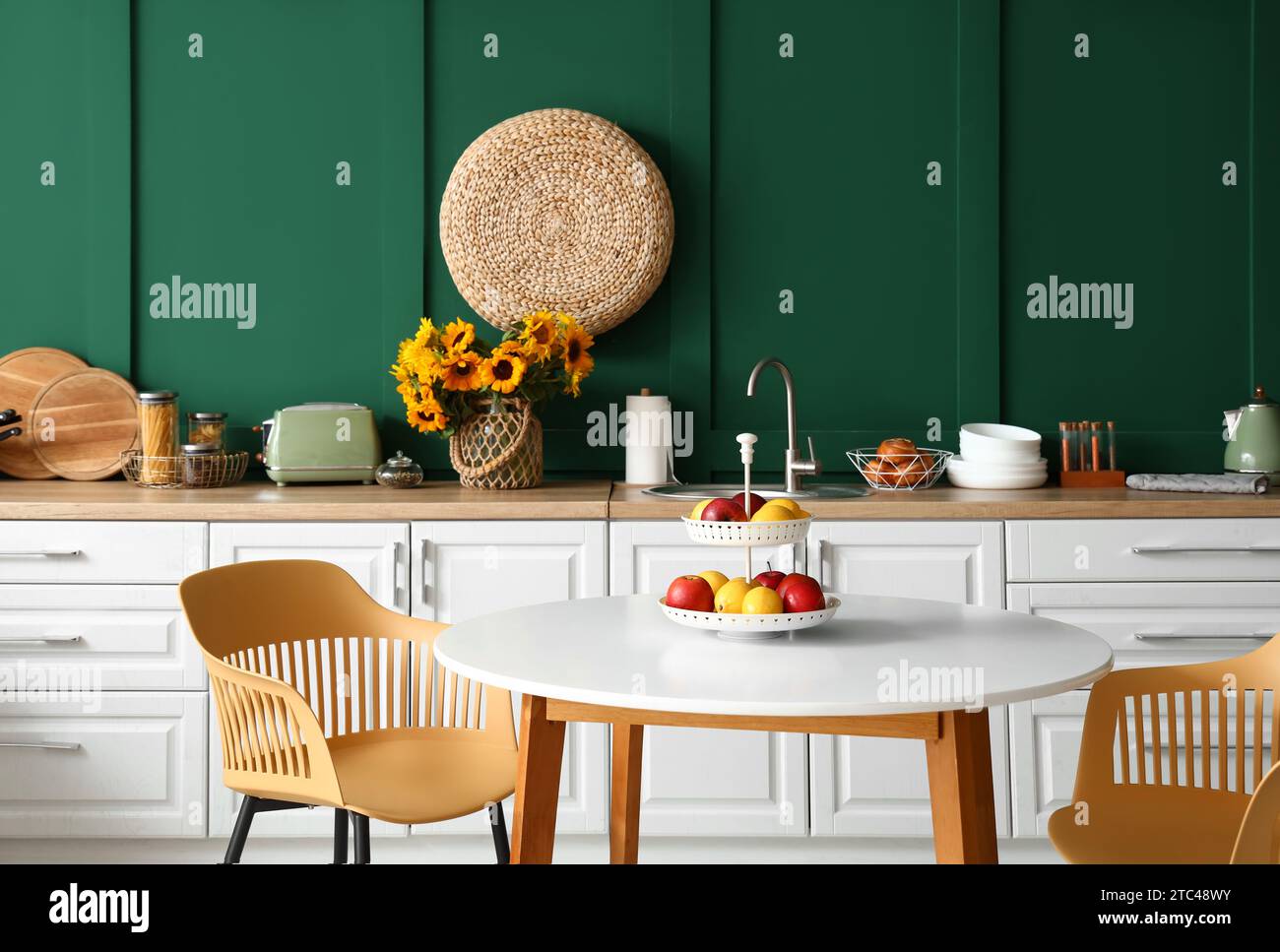 Interior of modern kitchen with white counters and dining table Stock ...
