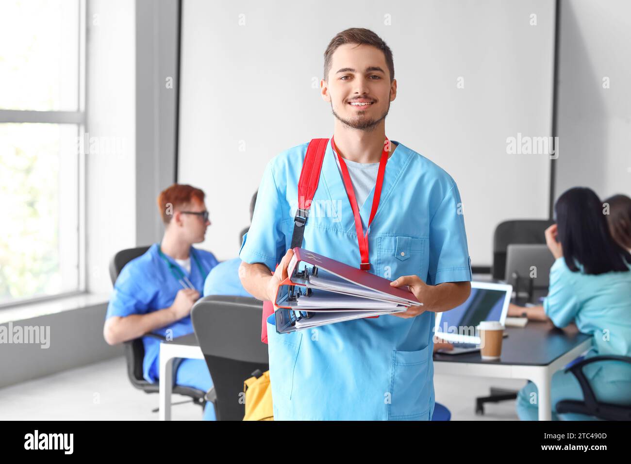 Male medical student with folders at university Stock Photo - Alamy