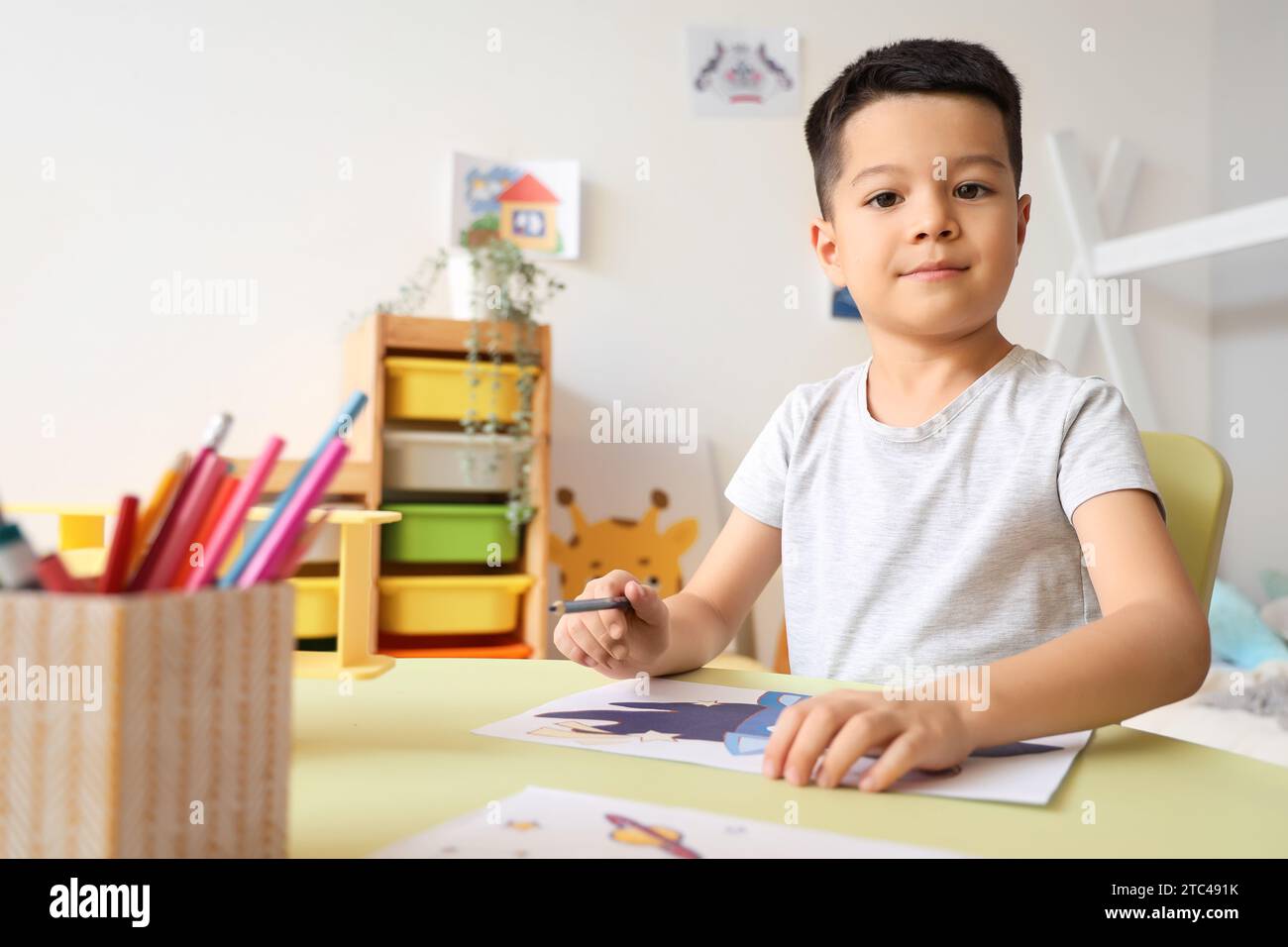 Little Asian boy drawing at home Stock Photo - Alamy