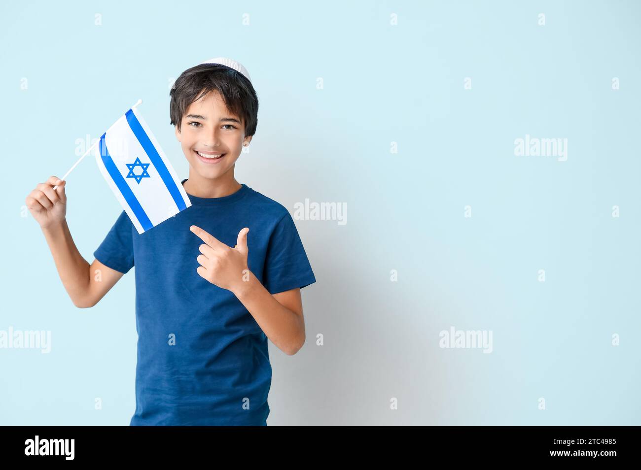 Little boy in kipa pointing at Israel flag on blue background Stock ...