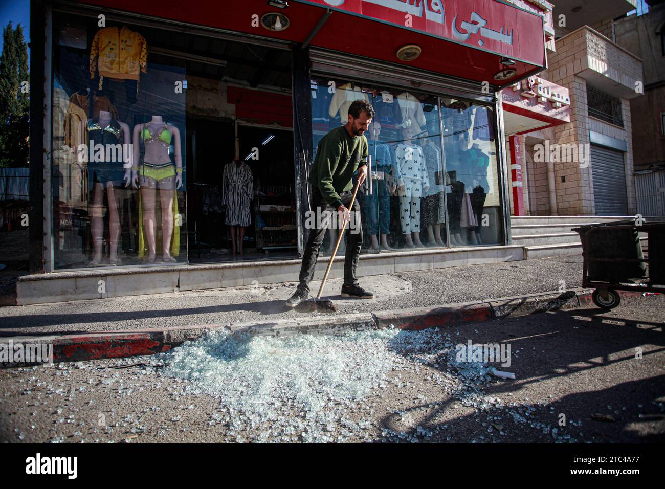 Tubas, Palestine. 10th Dec, 2023. A Palestinian cleans up the damage ...