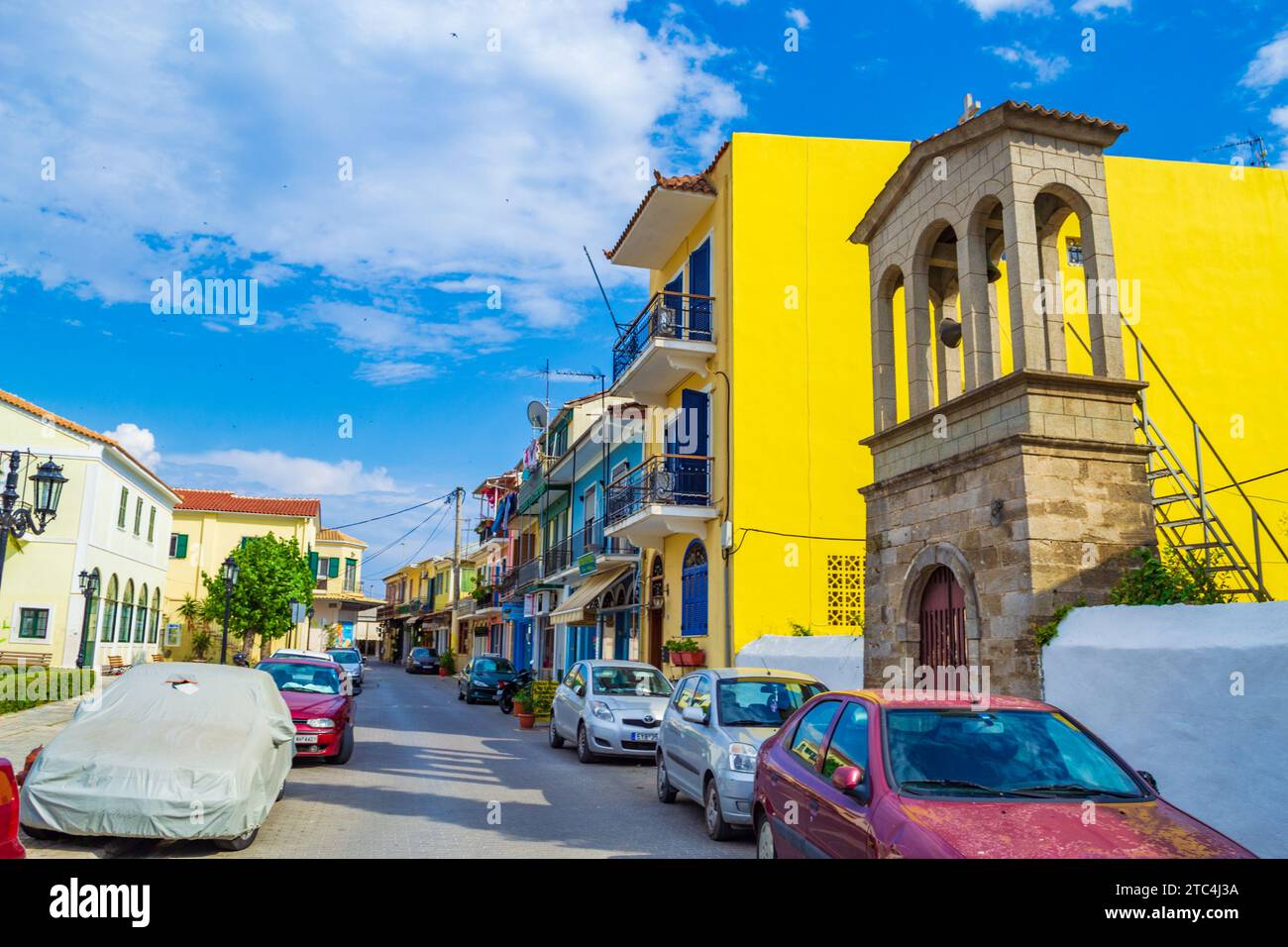 Lefkada, Greece-June 11th 2015:Colorful residential houses and tower of ...