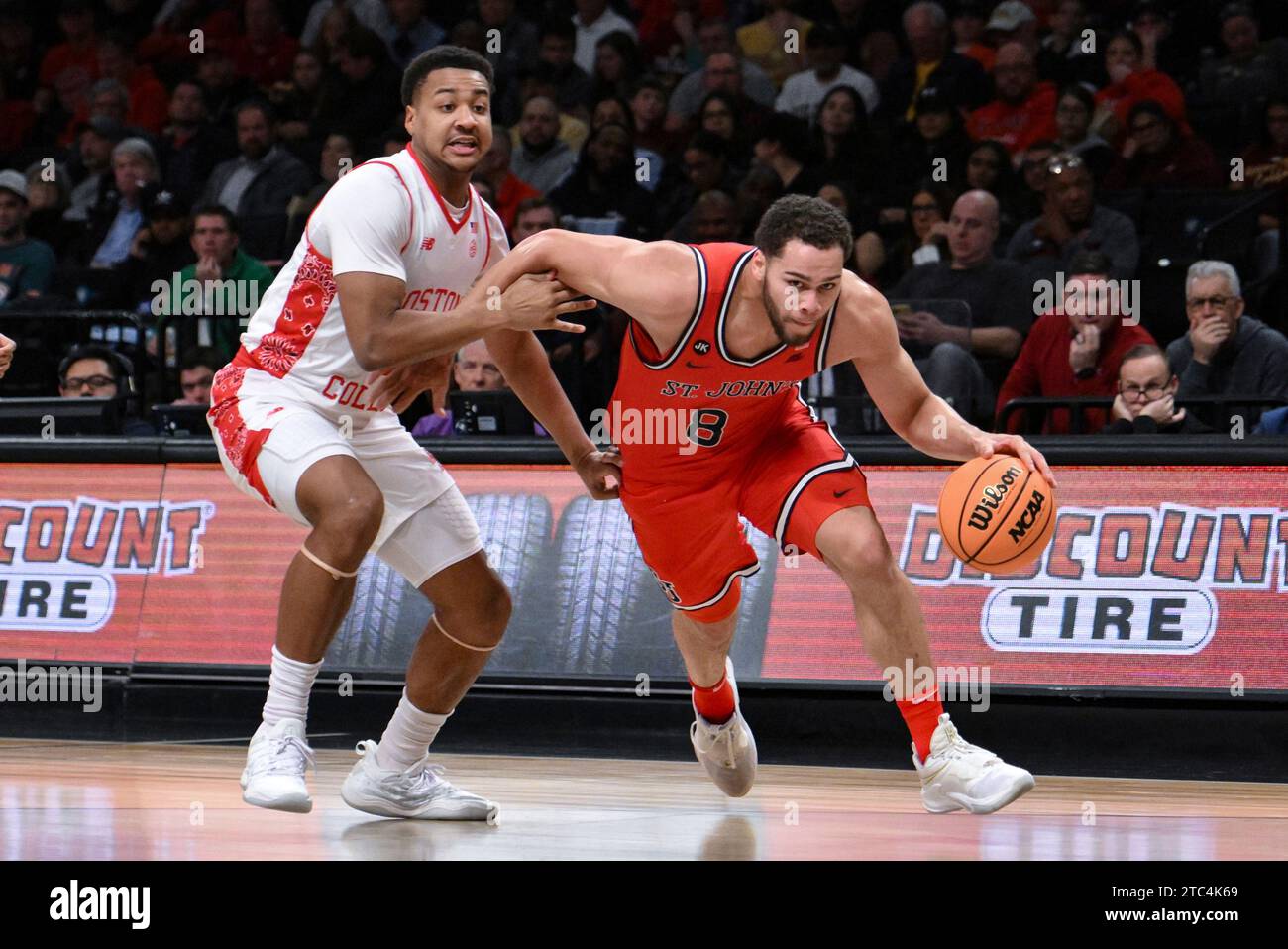 St. John's guard Chris Ledlum (8) drives to the basket while being ...
