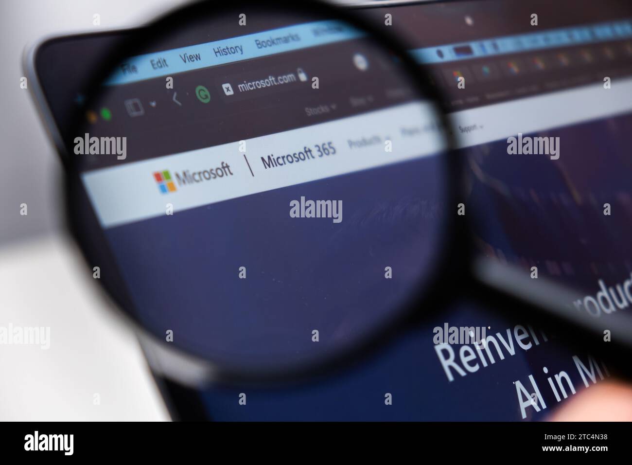 Microsoft 365 logo enlarged through a magnifying glass on a laptop ...