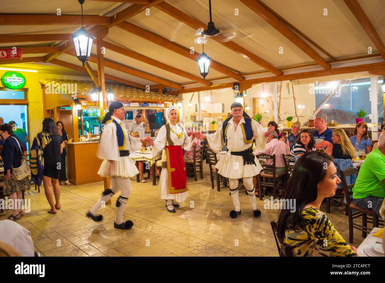 Greek dancers performing traditional dance at a restaurant Nydri ...