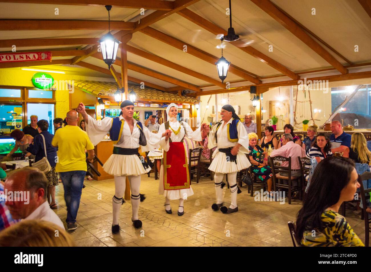 Greek dancers performing traditional dance at a restaurant Nydri ...