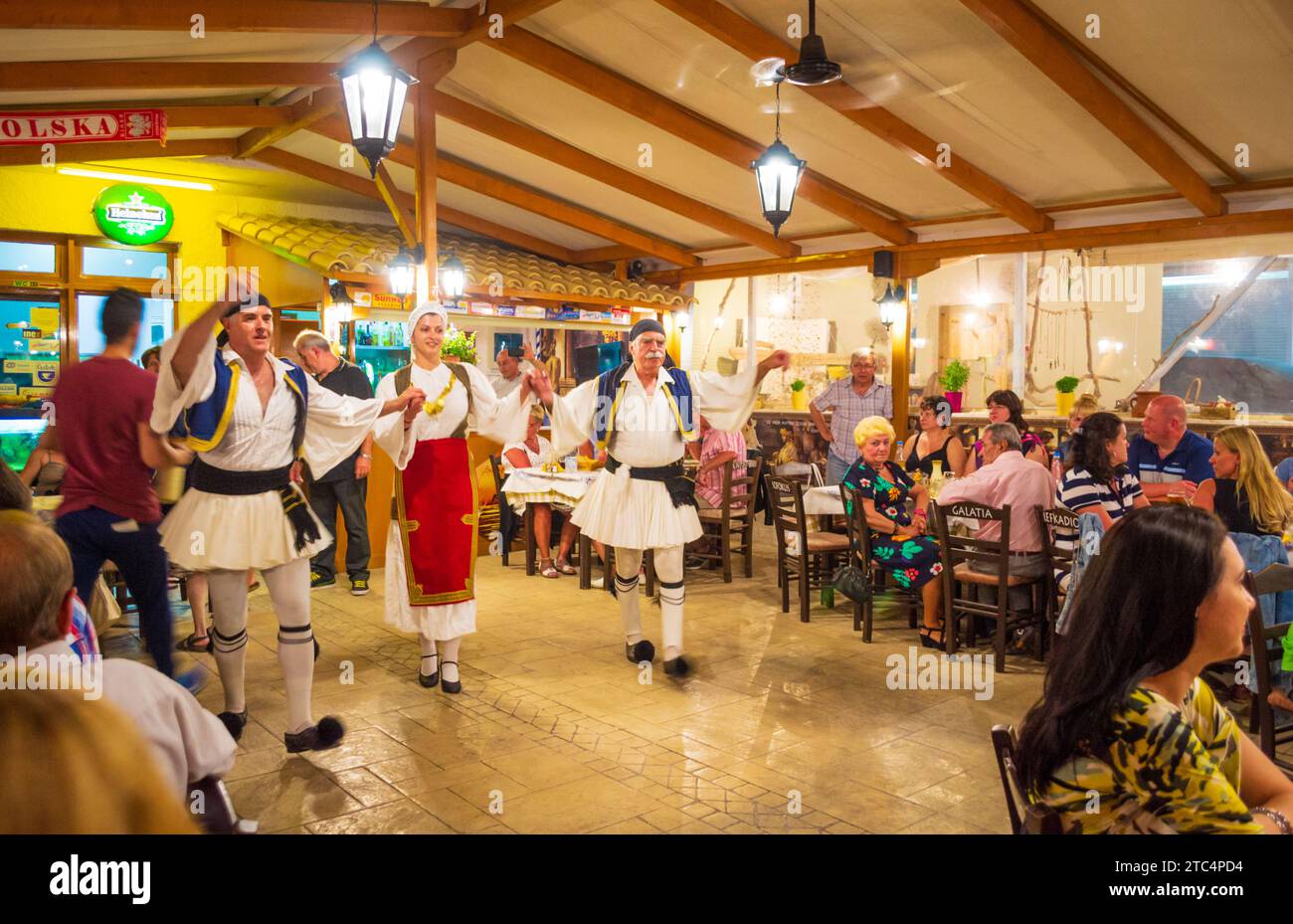 Greek dancers performing traditional dance at a restaurant Nydri ...