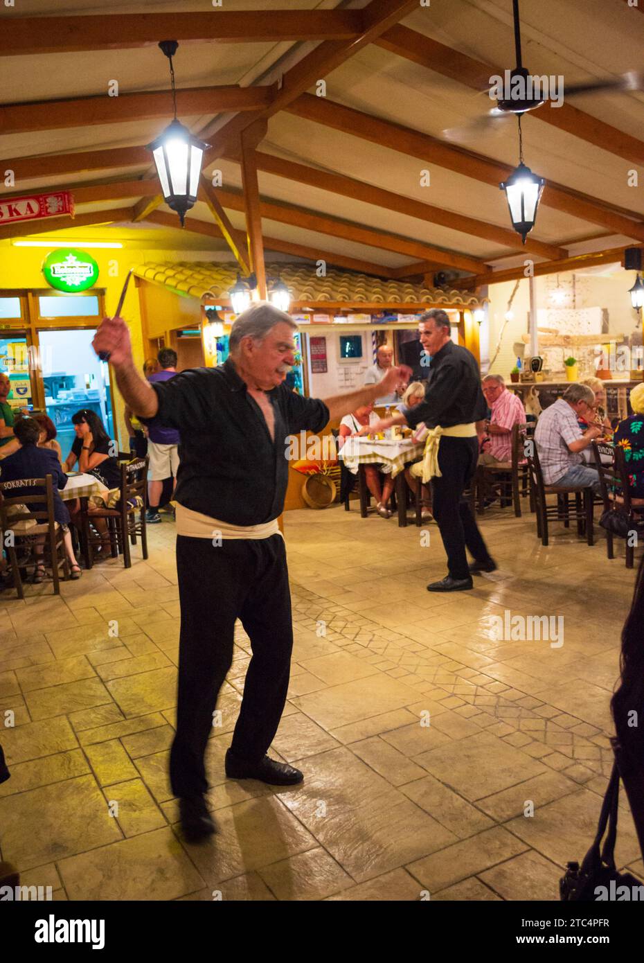 Greek dancers performing traditional dance at a restaurant Nydri ...