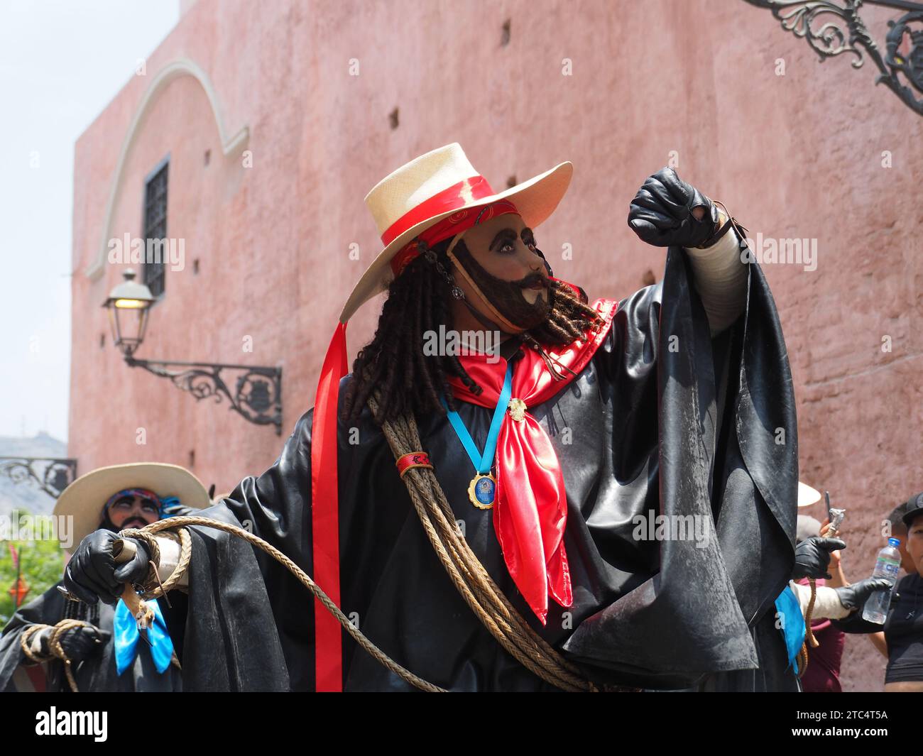 Man with mask and whip from an indigenous Peruvian folk dance group ...