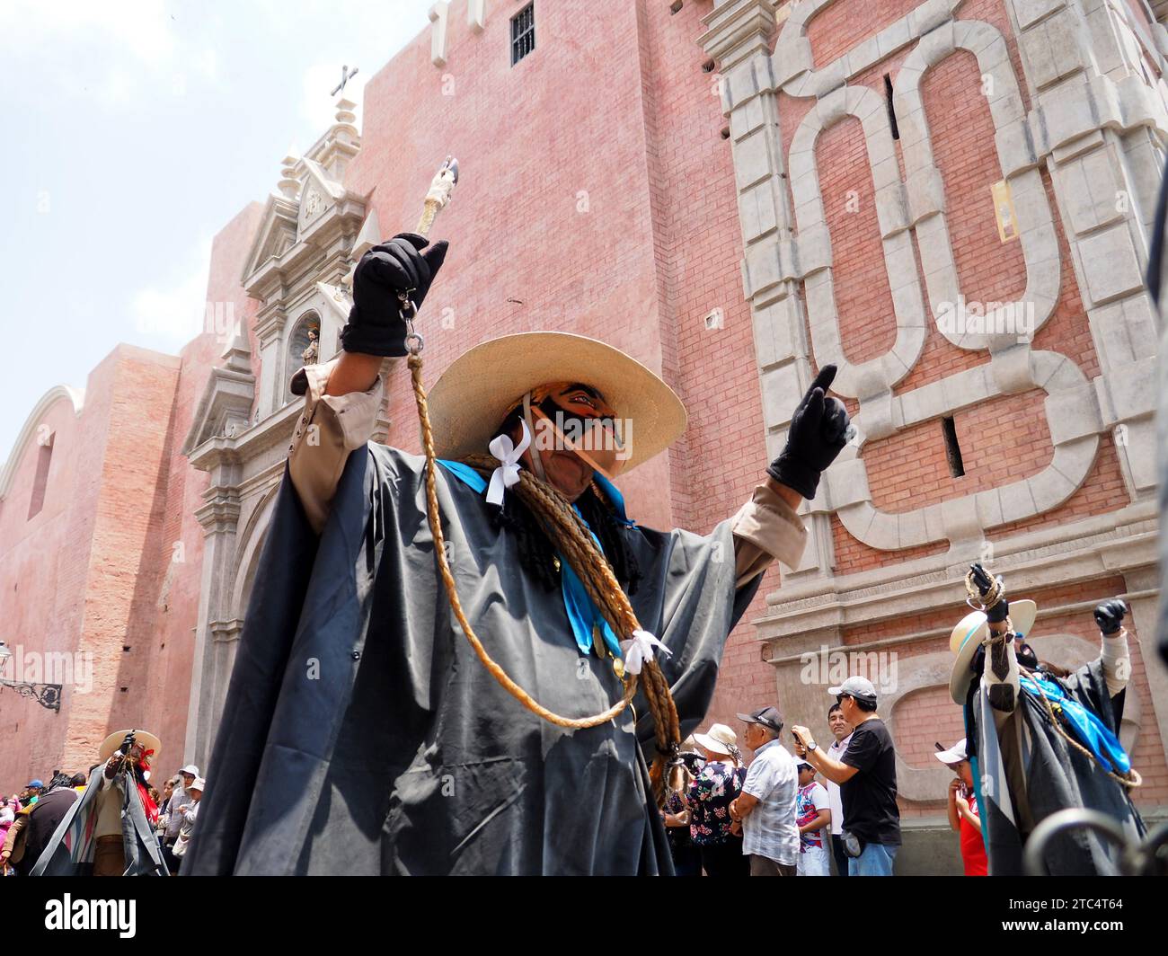 Man with mask and whip from an indigenous Peruvian folk dance group ...