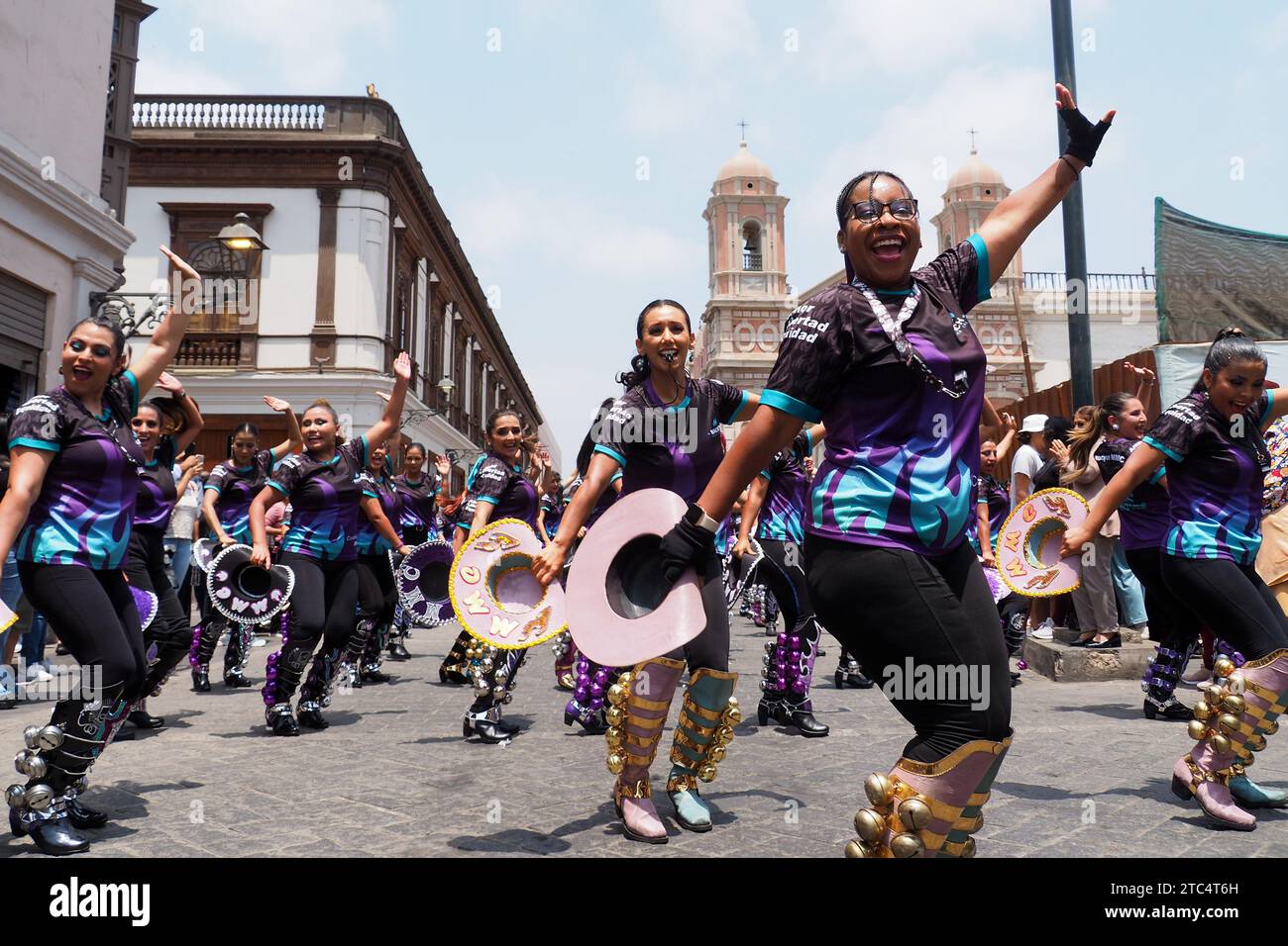 Troupe of women performing a dance and wearing traditional costumes ...