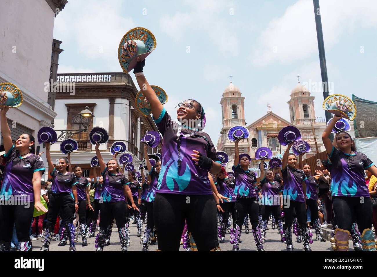Troupe of women performing a dance and wearing traditional costumes ...