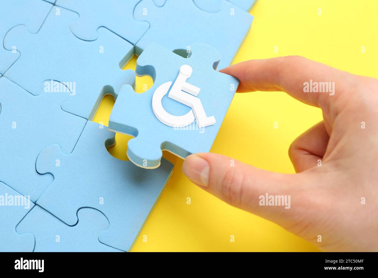 Inclusion concept. Woman putting light blue puzzle with international ...