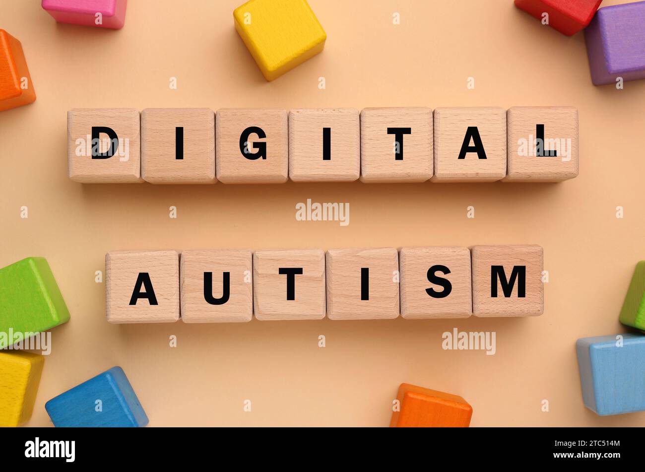 Phrase Digital Autism made of wooden cubes among colorful ones on beige ...