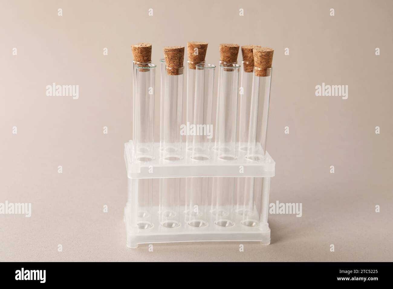 Test tubes in stand on beige background. Laboratory glassware Stock ...