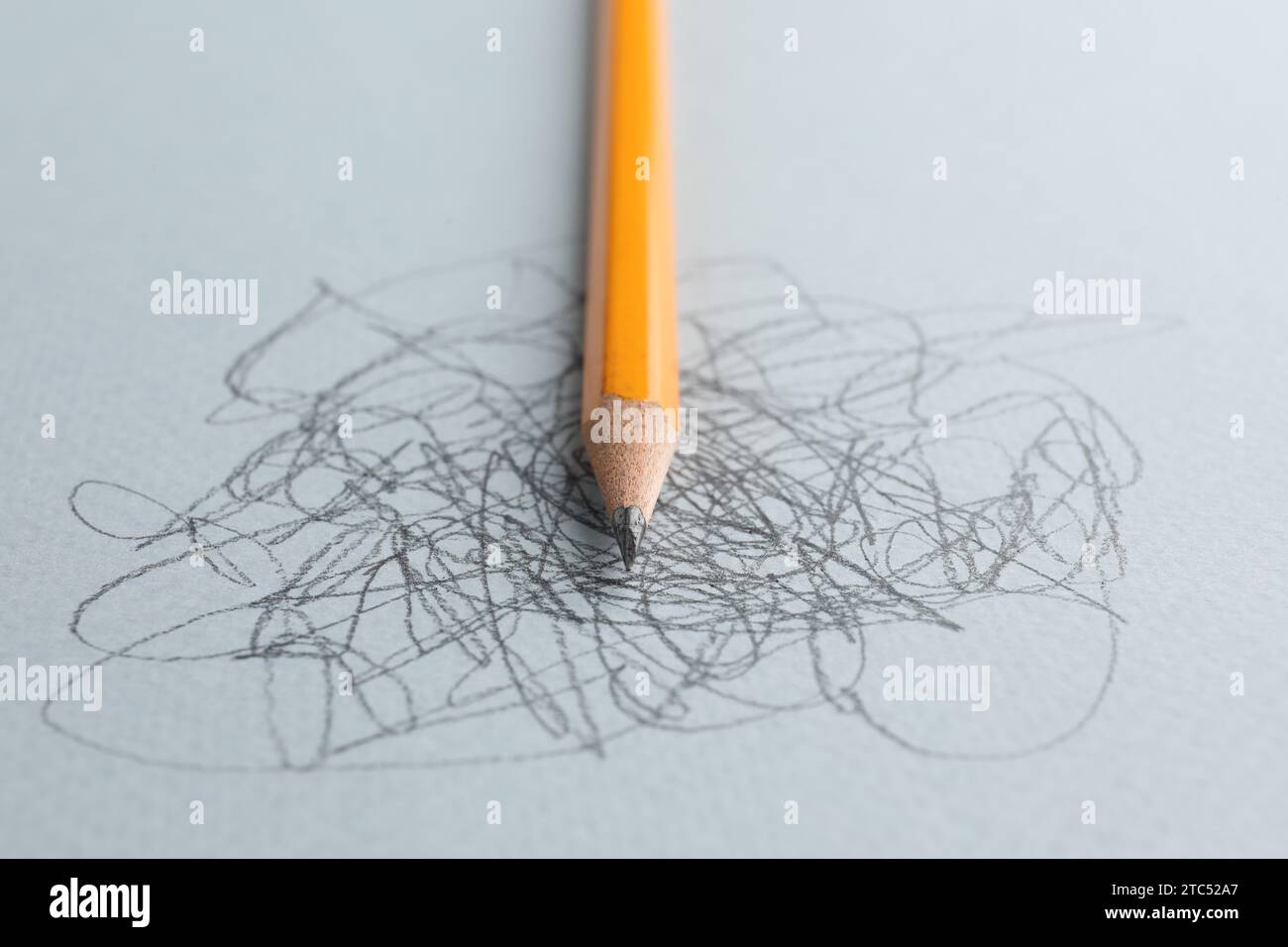 One sharp graphite pencil and scribbles on white background, closeup ...