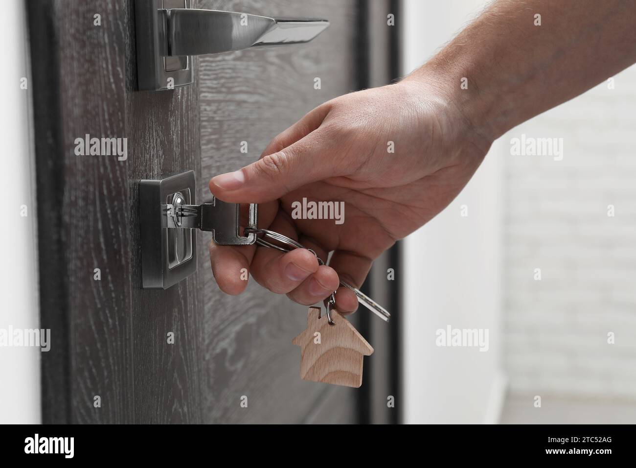Man unlocking door with key, closeup view Stock Photo - Alamy