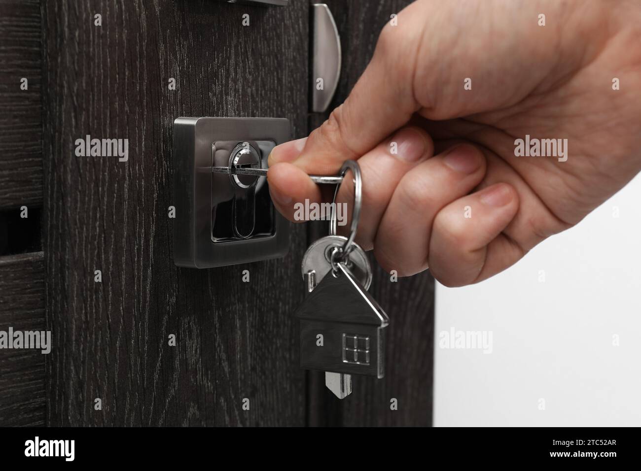 Hand man locking home door hi-res stock photography and images - Alamy