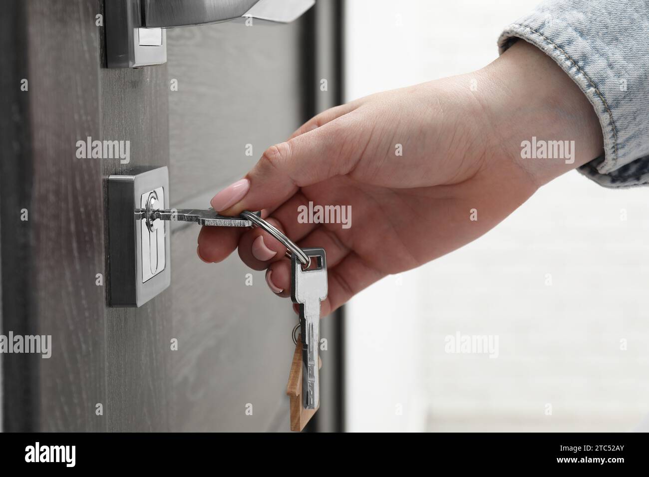 Person unlocking wooden door hi-res stock photography and images - Alamy