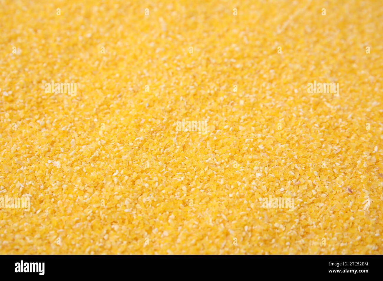 Raw corn grits as background, closeup view Stock Photo - Alamy