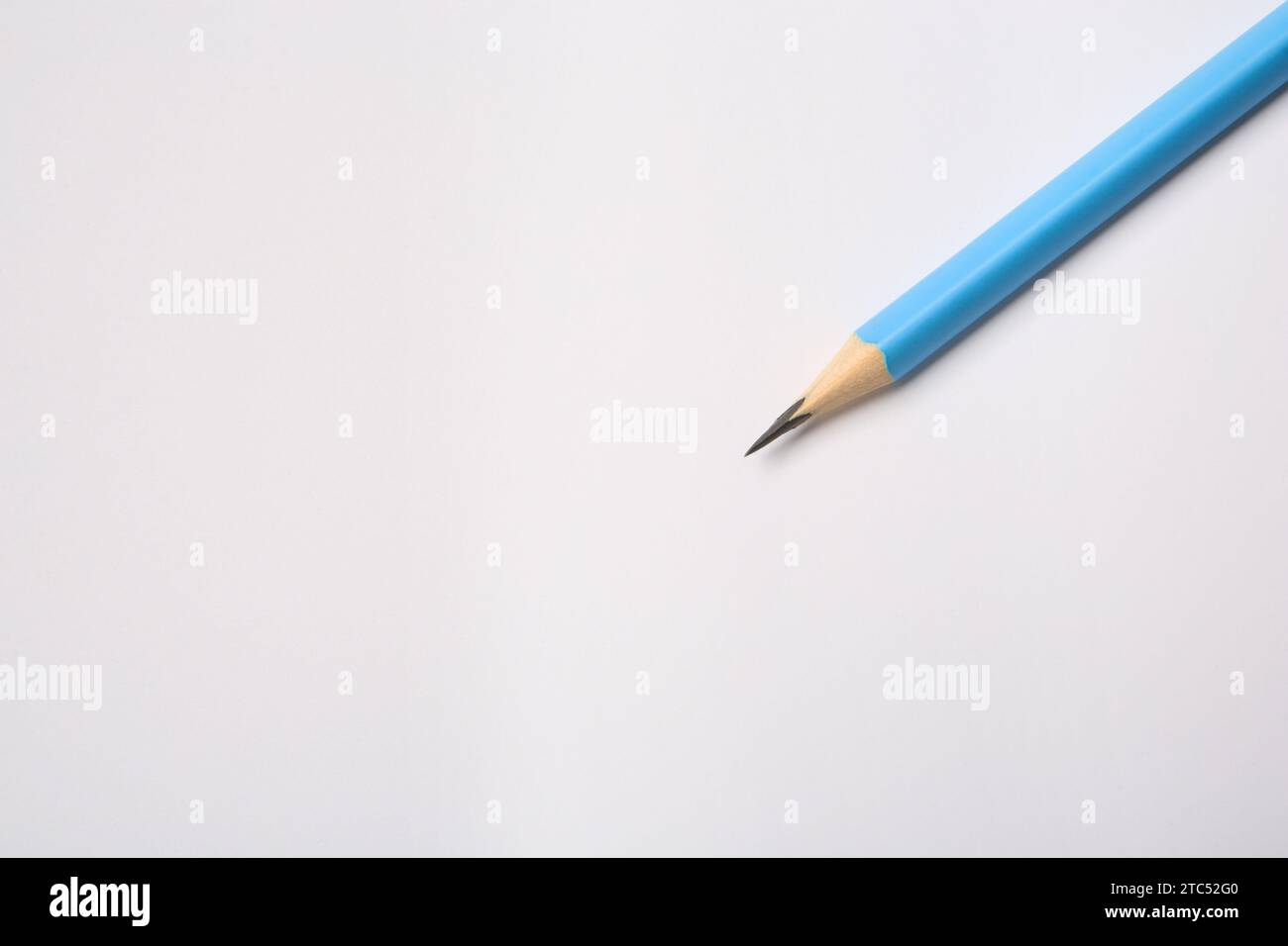 Sharp graphite pencil on white background, top view. Space for text ...