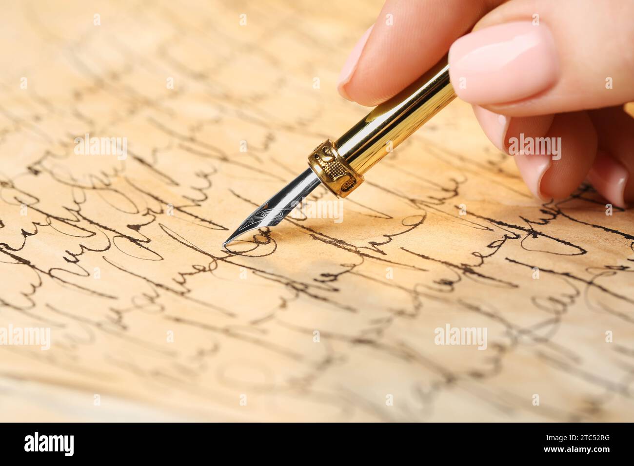 Woman writing letter with fountain pen, closeup Stock Photo - Alamy