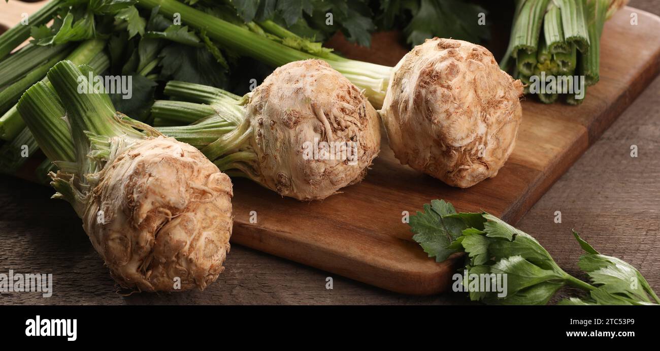 Fresh raw celery roots on wooden table, closeup. Banner design Stock ...