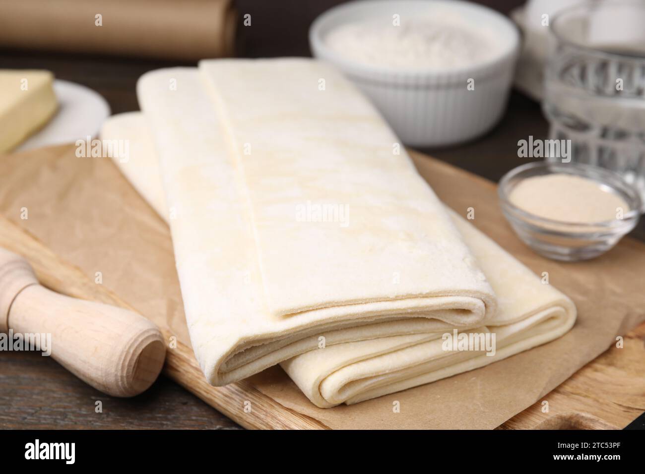 Raw puff pastry dough on wooden table, closeup Stock Photo - Alamy