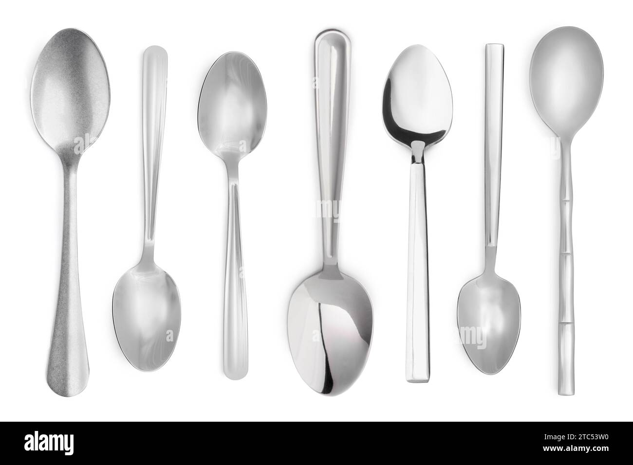 Different stylish silver spoons on white background Stock Photo - Alamy