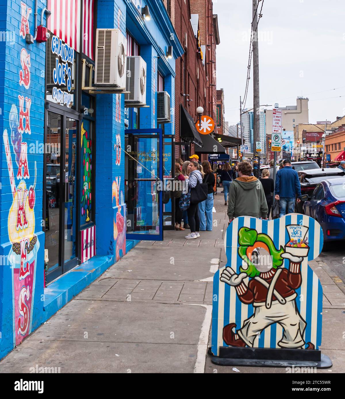 People outside of a candy store on Penn Avenue in the Strip District ...