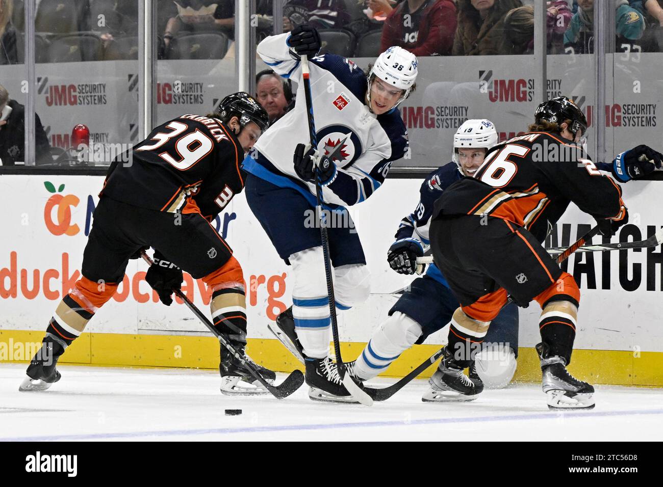 Winnipeg Jets center Morgan Barron passes the puck past Anaheim Ducks ...