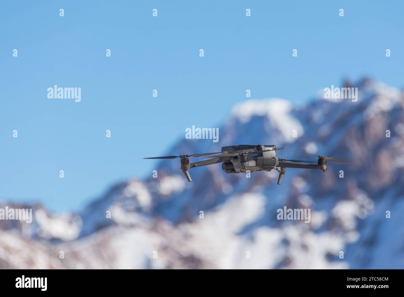 Flying drone over mountains covered hi-res stock photography and images ...