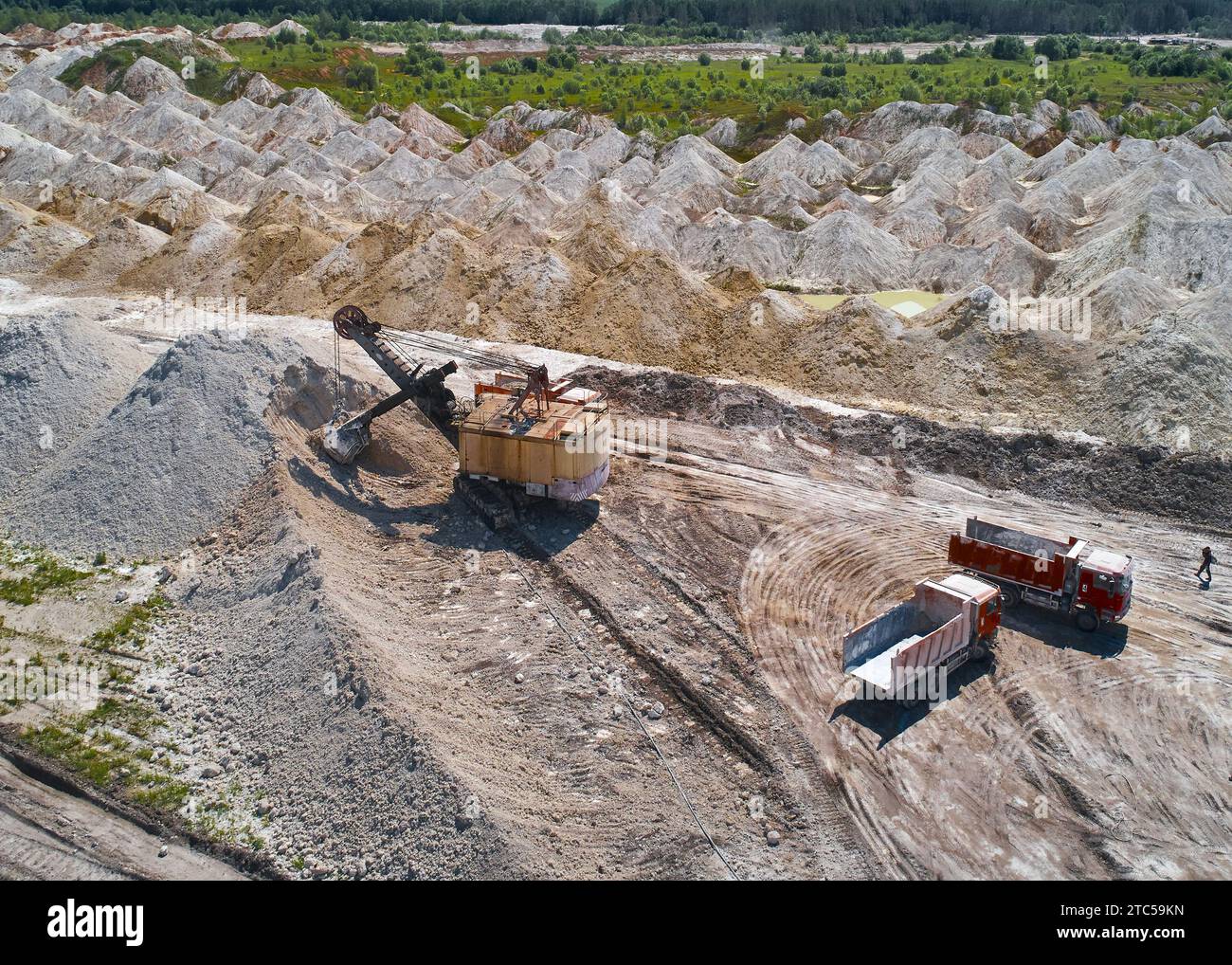 Tip trucks and shovel mining excavatorin chalk quarry Stock Photo - Alamy