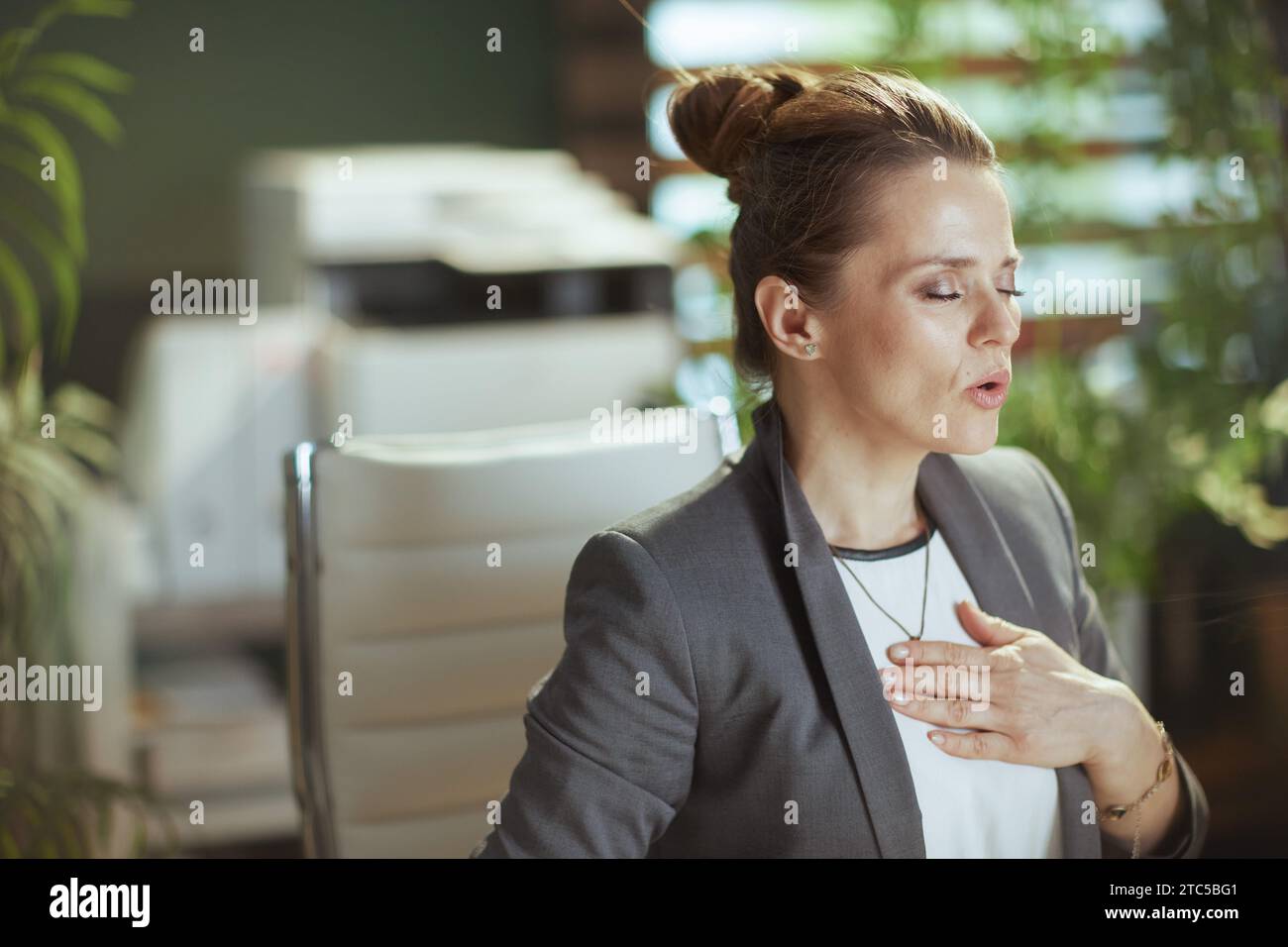 Sustainable workplace. relaxed modern business woman in modern green ...