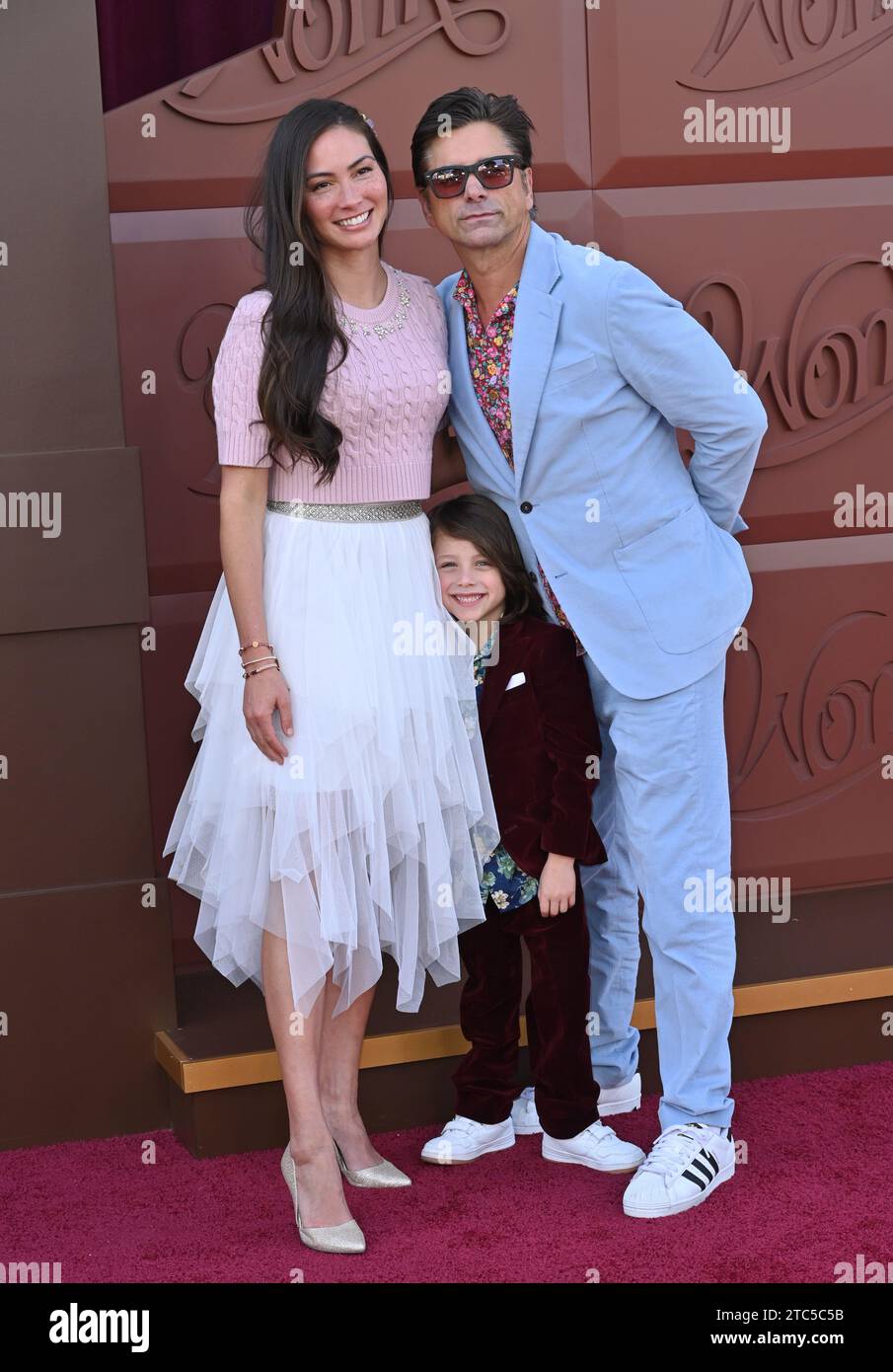 LOS ANGELES, USA. December 10, 2023: Caitlin McHugh, John Stamos ...