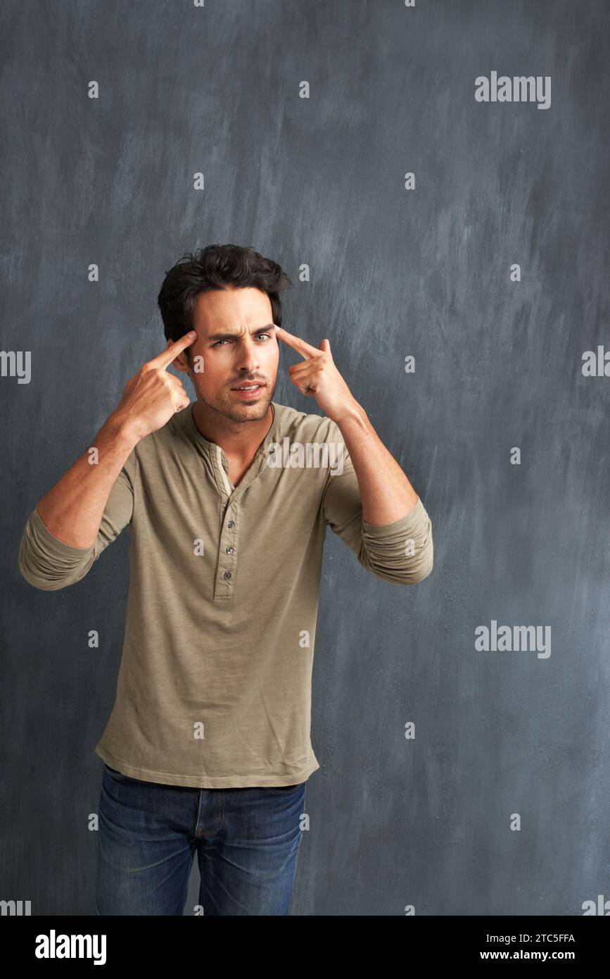 Annoyed, thinking and portrait of man by a wall with doubt, moody and ...