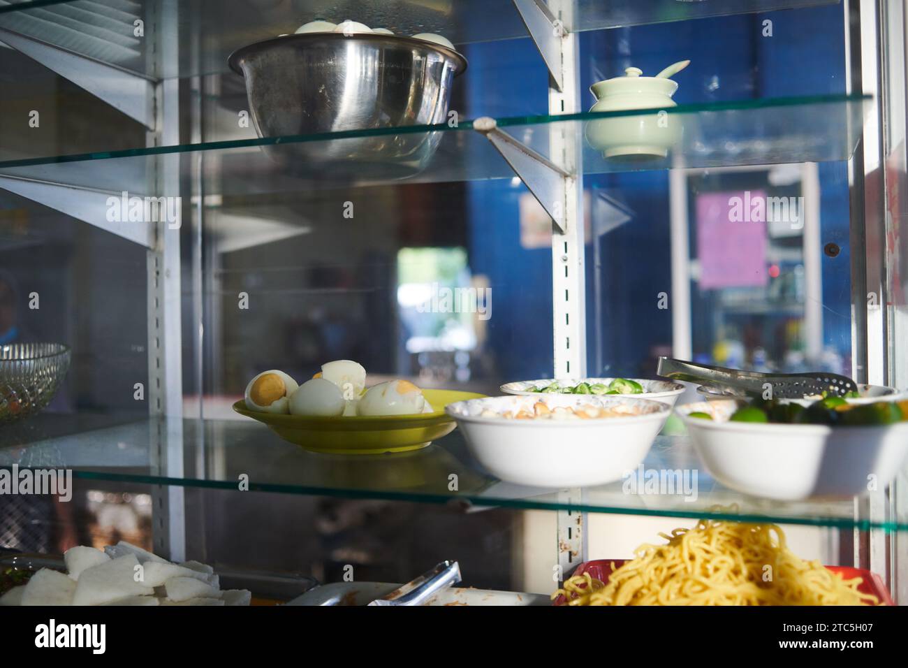 Glass display shelves in little restaurant on Pulau Ubin in Singapore ...