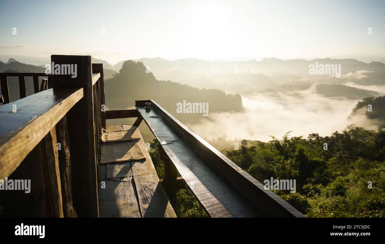 Mountain Top in the clouds over flowing fog between mountain peaks ...