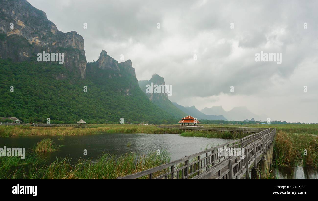 Wooden walkway and pavilion in the middle of freshwater marsh, blue sky ...